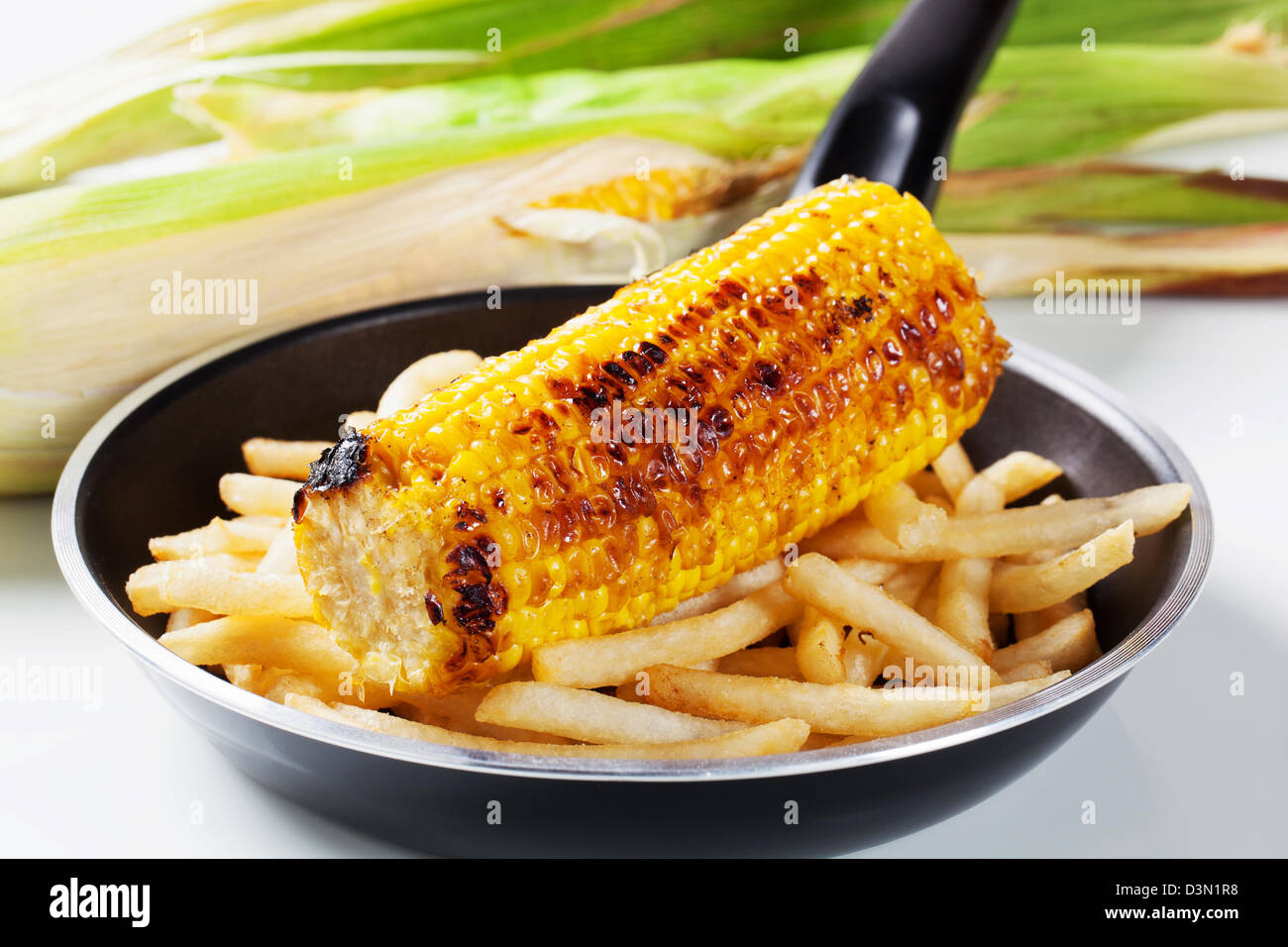 Grilled corn and French fries Stock Photo - Alamy
