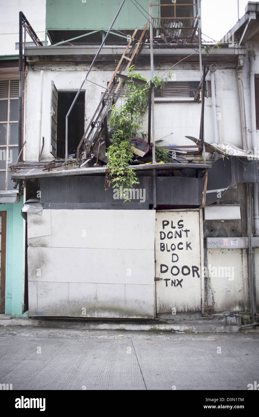 Run Down Building with parking sign Stock Photo - Alamy