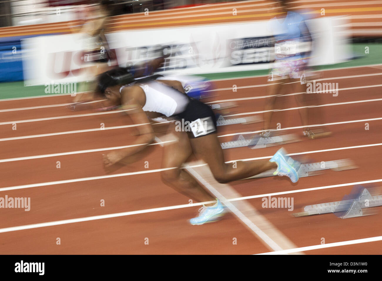 Female sprinter warming up out of the starting blocks at the 2013 ...