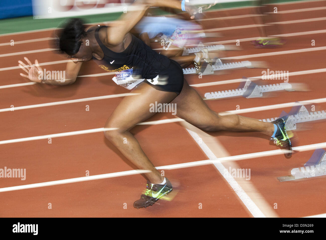 Female sprinter warming up out of the starting blocks at the 2013 ...