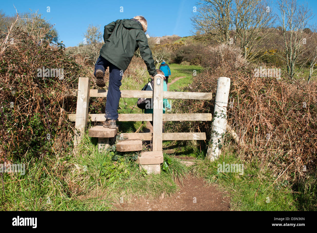 Walkers climbing over stile hi-res stock photography and images - Alamy