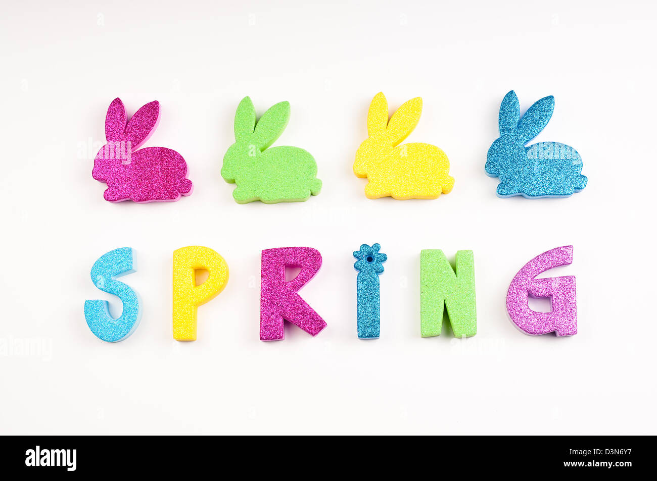 The word Spring in glitter colors of blue, yellow, purple, green. The ...