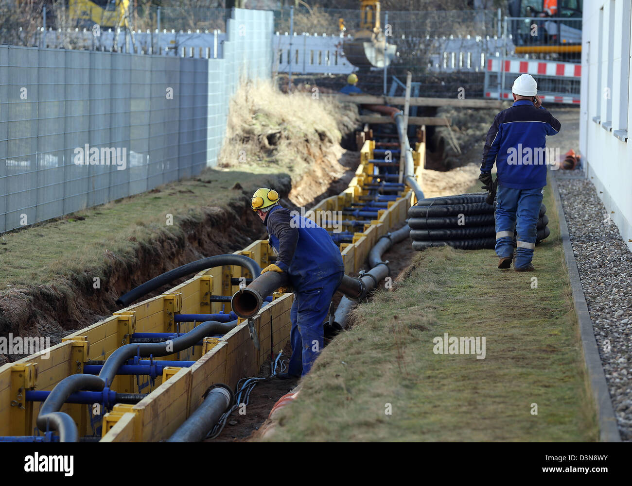 Workers lay pipes to drain kerosene near the Shell refinery in ...