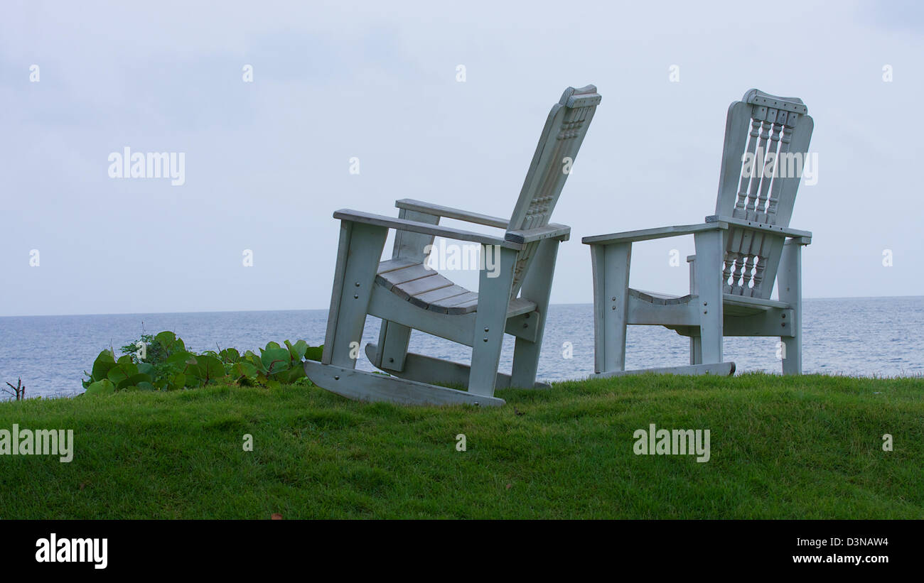 Two chairs on seaside cliff representing relaxation, peace, and ...