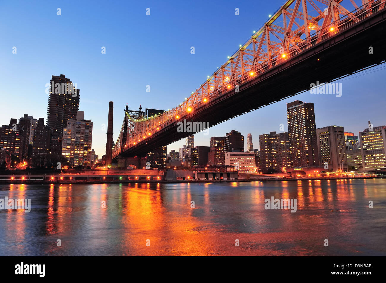 Queensboro Bridge over New York City East River at sunset with river ...