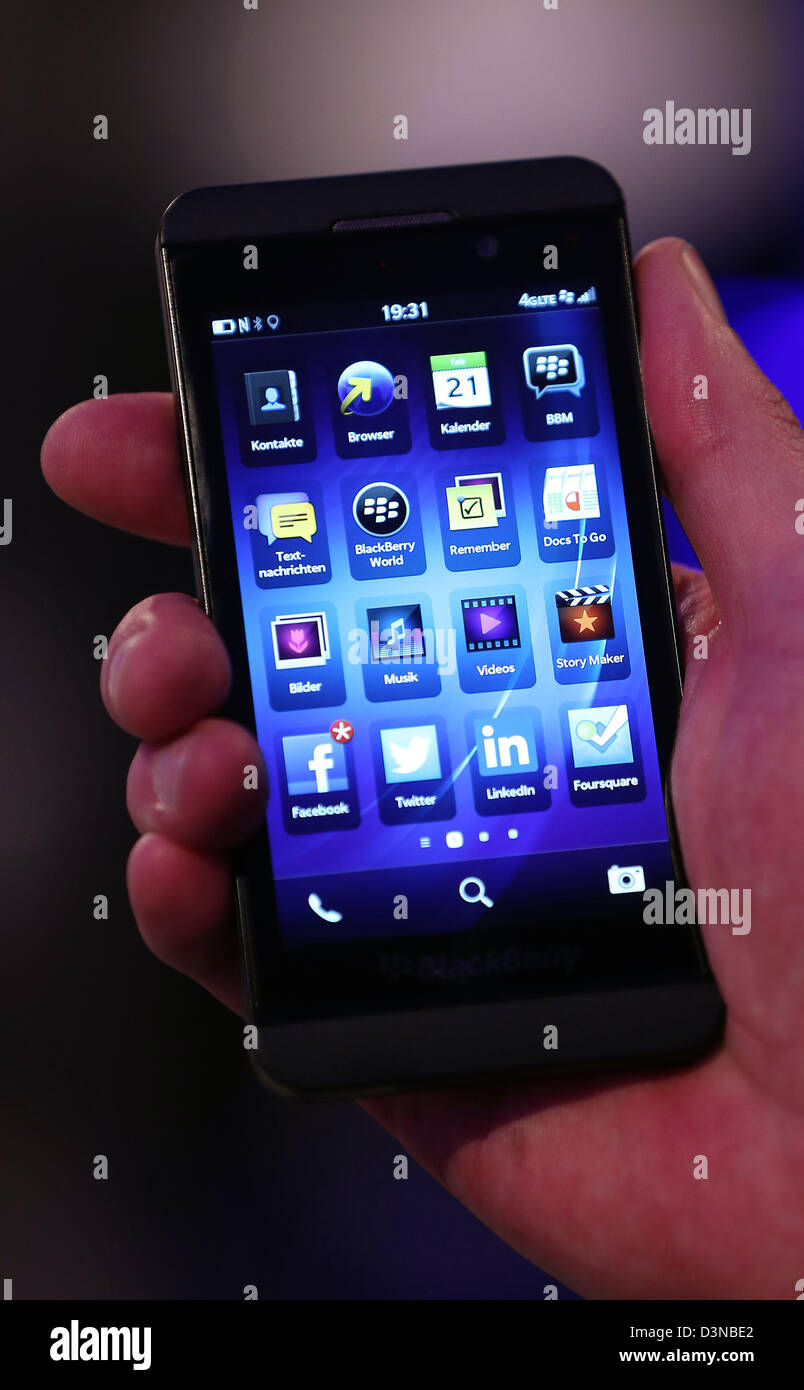 A man holds the new BlackBerry touch screen smartphone, the BlackBerry ...