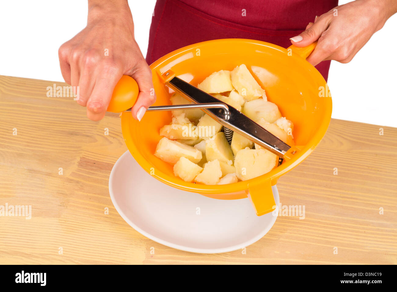 Mashing potatoes using a food mill Stock Photo - Alamy