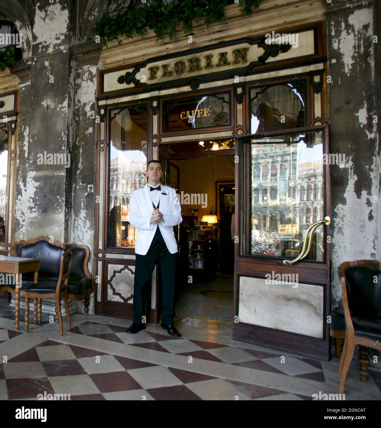 A waiter stands at the entrance area of the famous cafe 'Florian' at ...