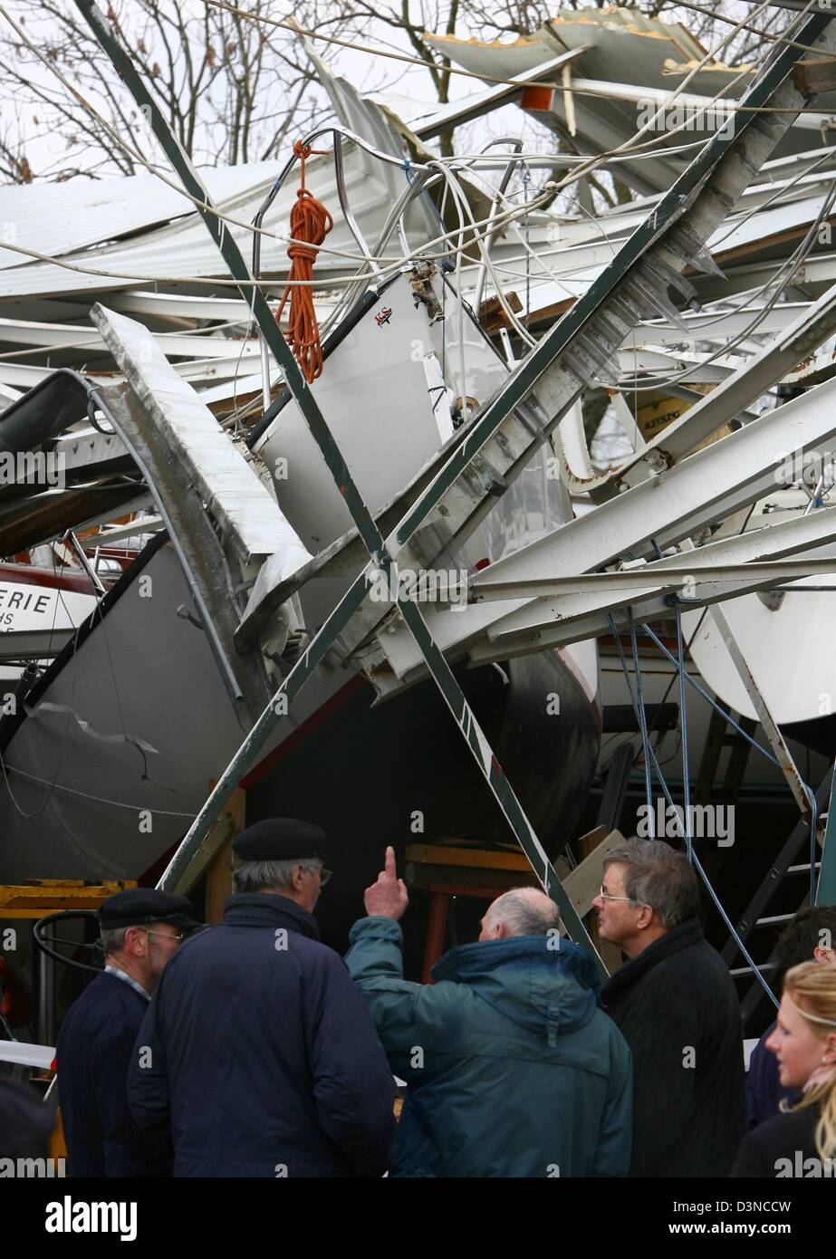 Boat owners stand at a tumbled over boathouse in Hamburg, Germany ...