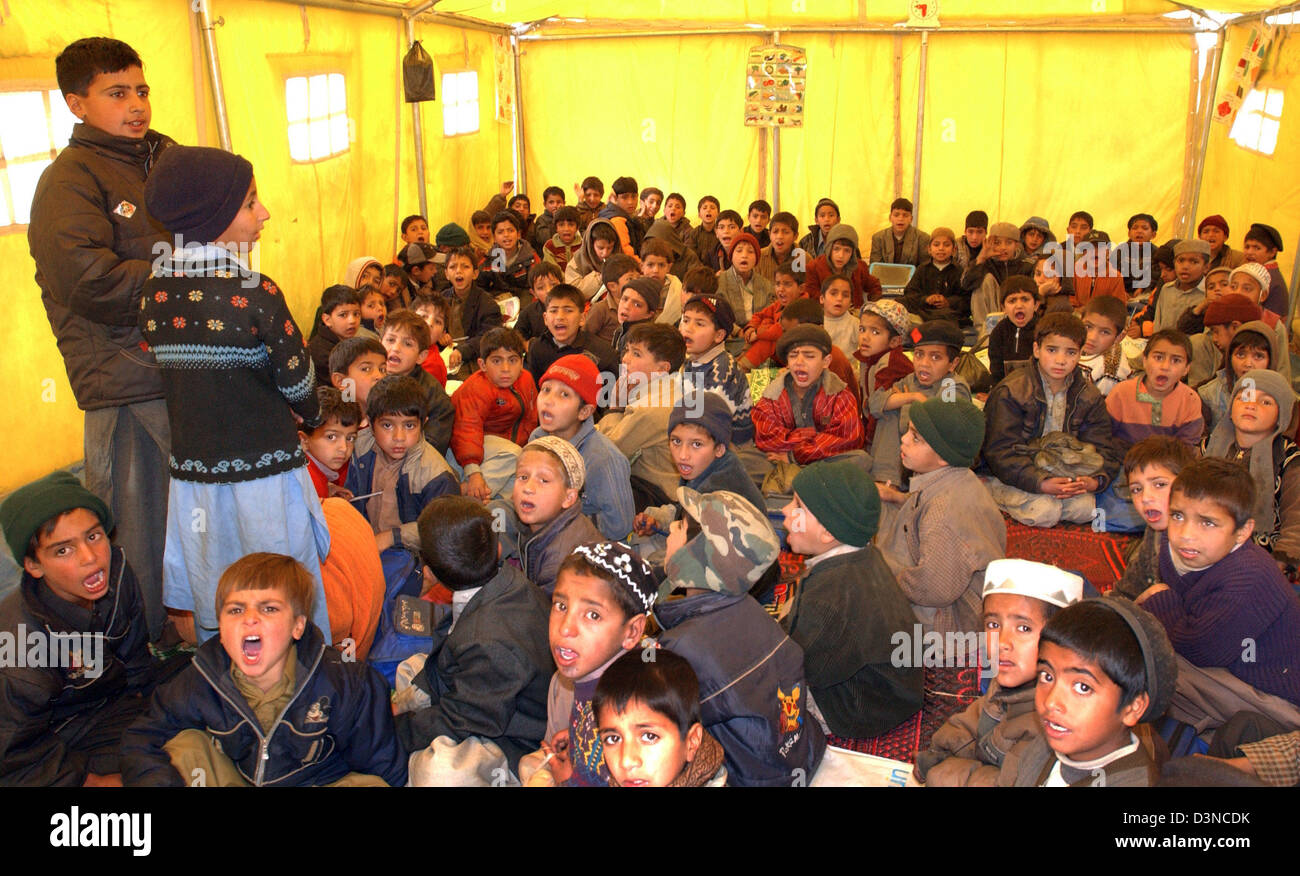 School children sit in a UNICEF sponsored school tent listening to the ...