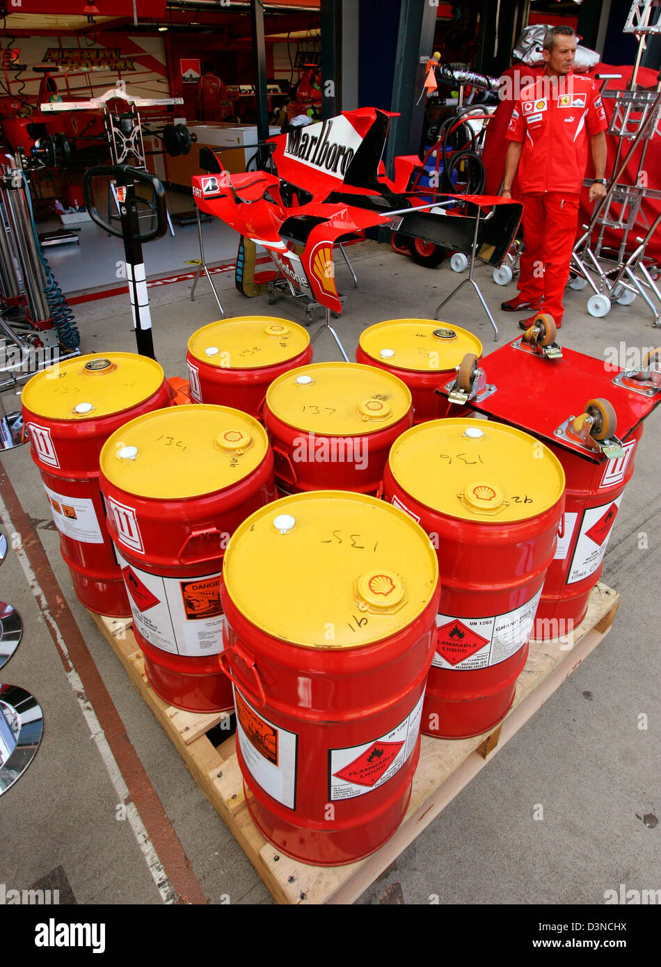 The picture shows a Ferrari mechanic in the team's garage at the Albert ...