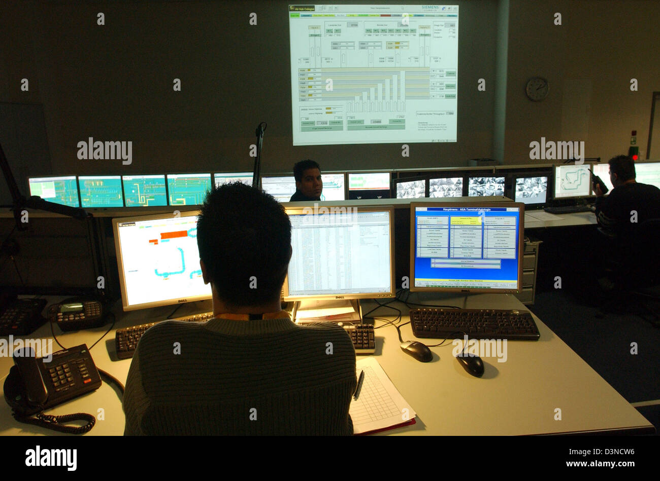 An employee monitors computers at the cargo centre of the American ...