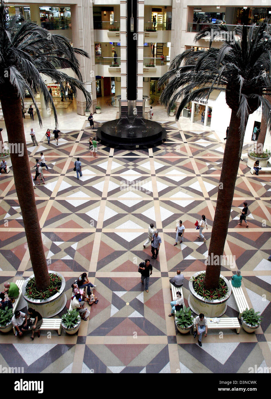 The picture shows people strolling in the Raffles City shopping mall in ...