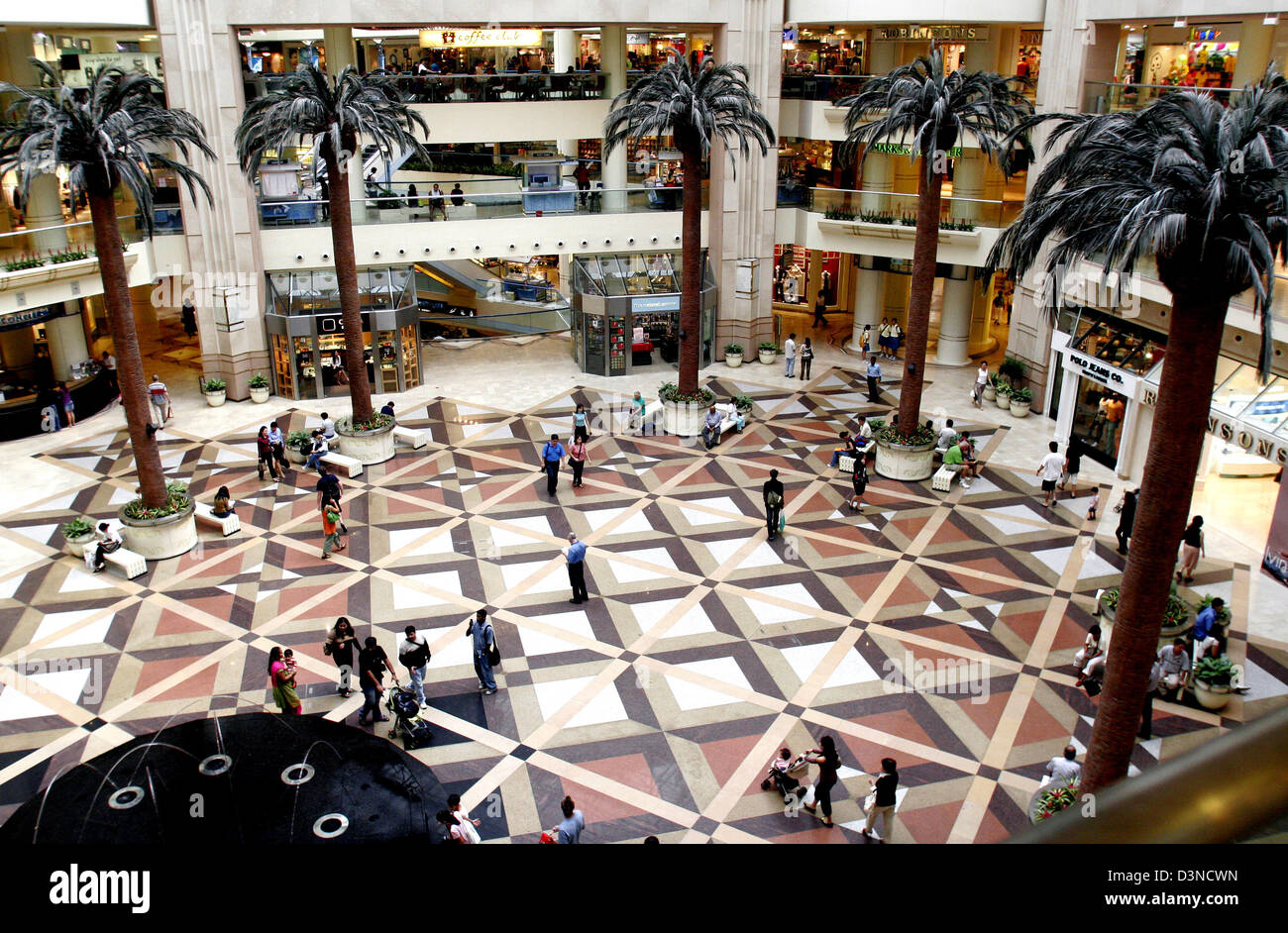 The picture shows people strolling in the Raffles City shopping mall in ...