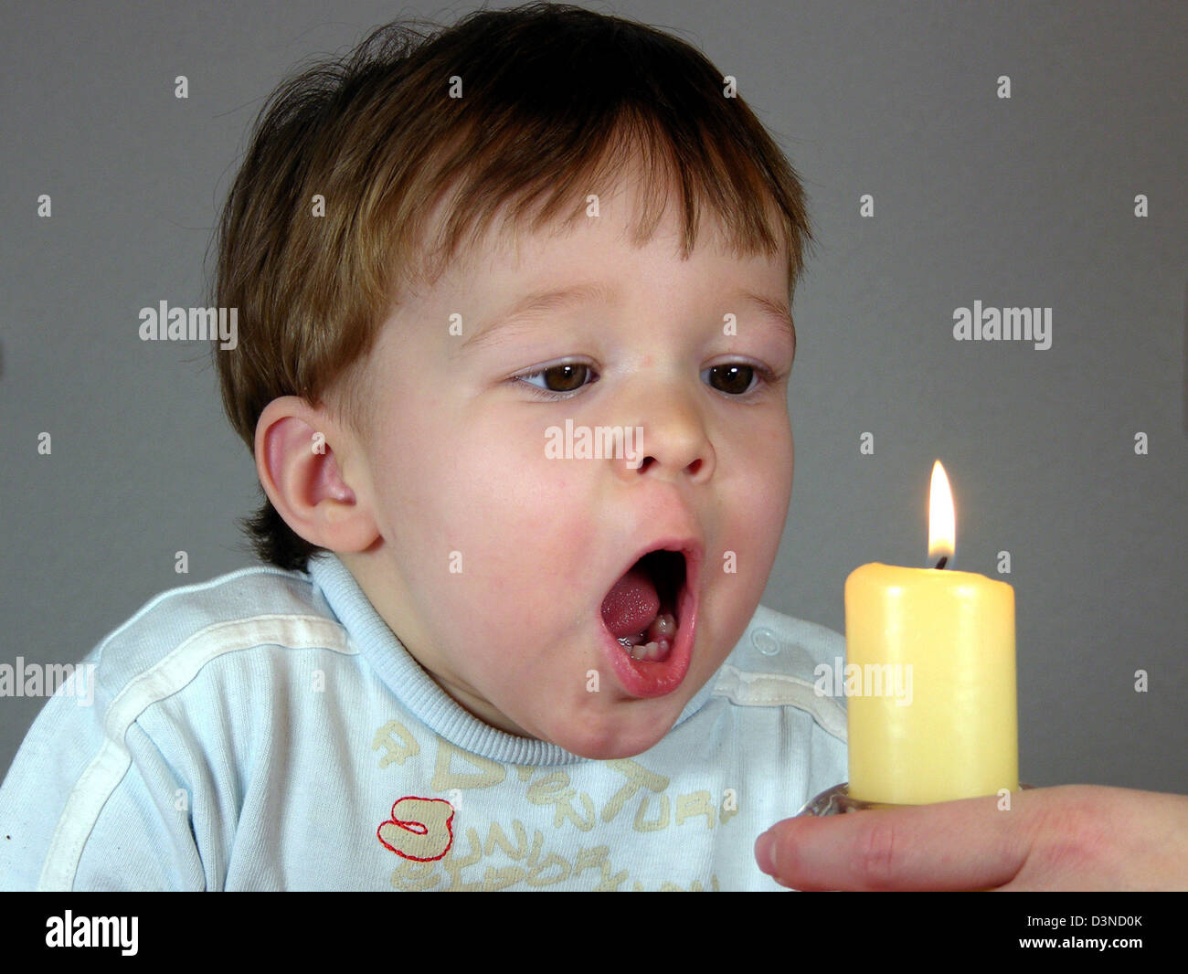 A little child takes a deep breath to blow out a candle, 08 December ...