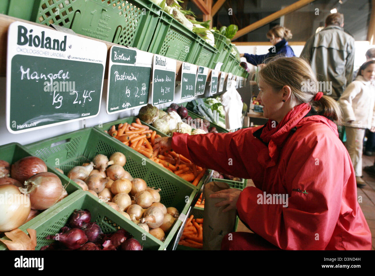 (dpa file) Customers help themselves to organic produce at a farm store ...