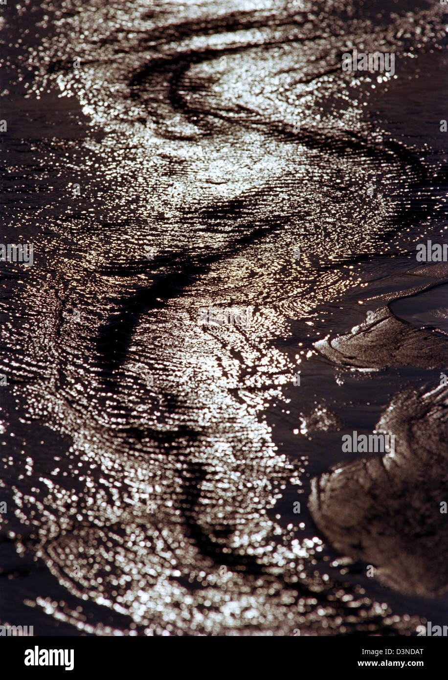 (dpa file) Water flows off the beach leaving a rippled surface behind ...