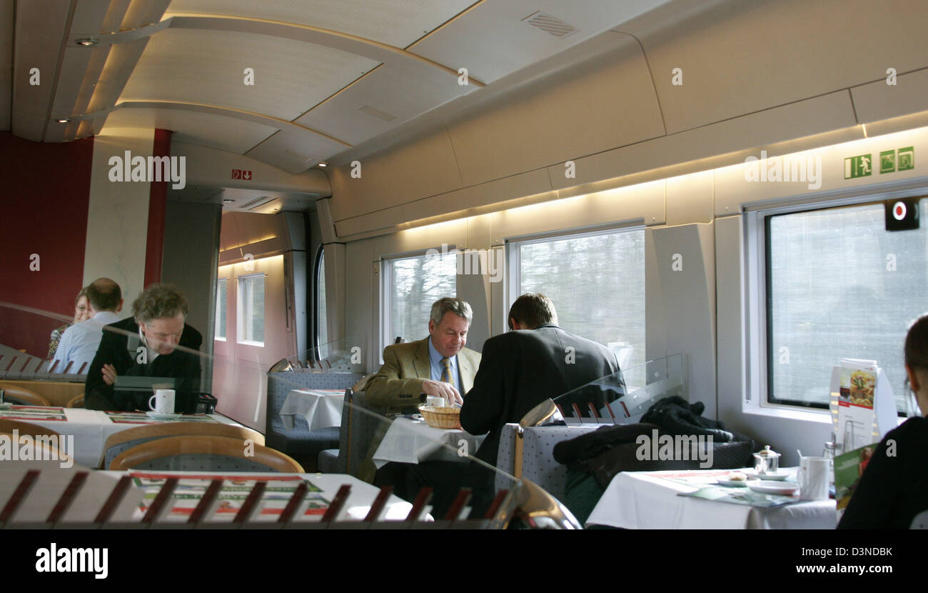 Train passengers are seated in the restaurant car of an Intercity ...