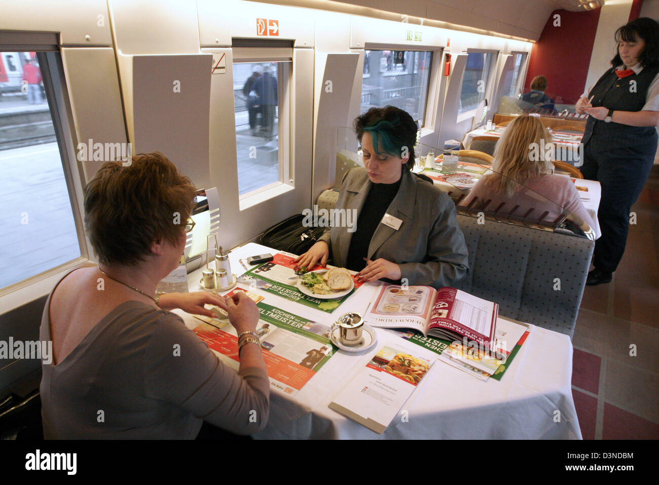 Train passengers are seated in the restaurant car of an Intercity ...