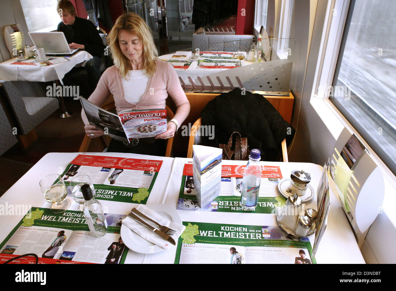 A passenger studies the menu card in the restaurant car of an Intercity ...