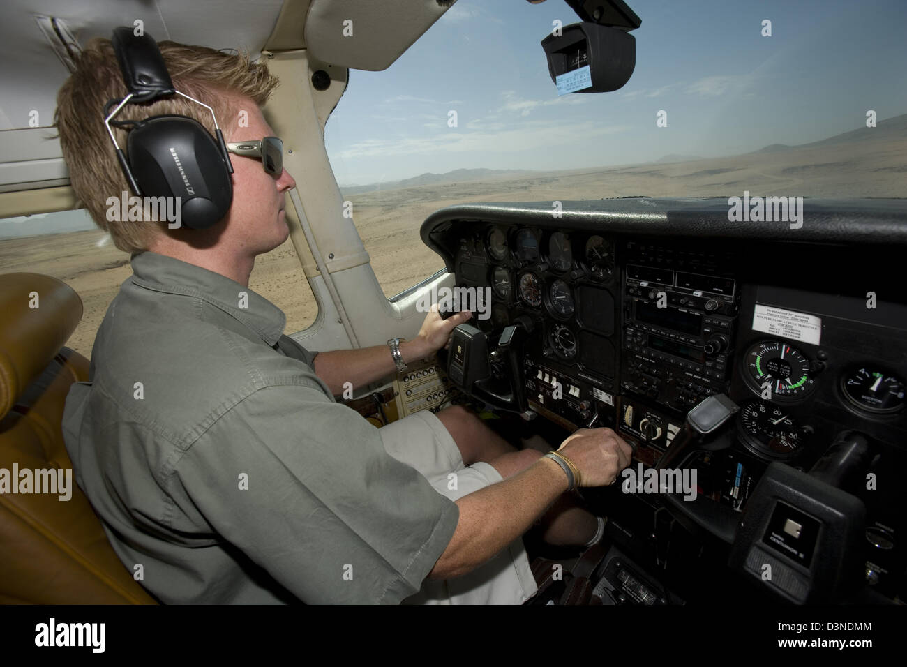Pilot at controls of private jet in flight, Namibia Stock Photo - Alamy