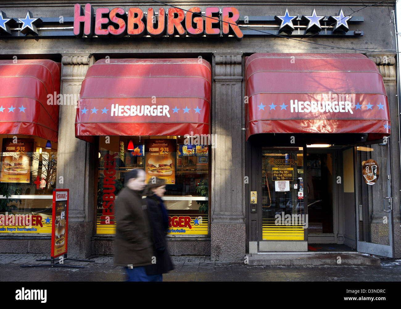 Pedestrians walk past a branch of the Finnish fast food chain Hesburger ...