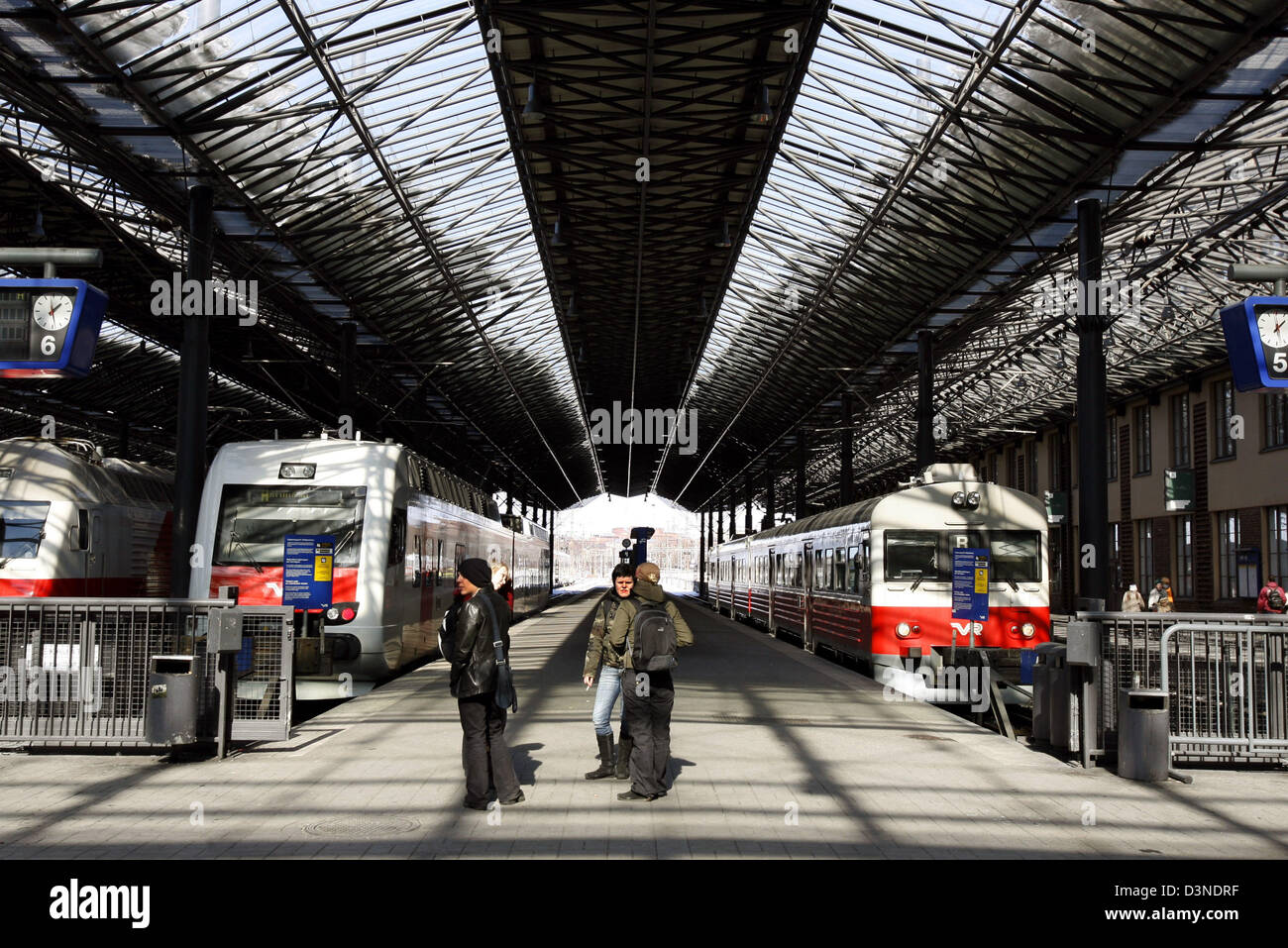 Trains stand at the platforms at the central station in Helsinki ...