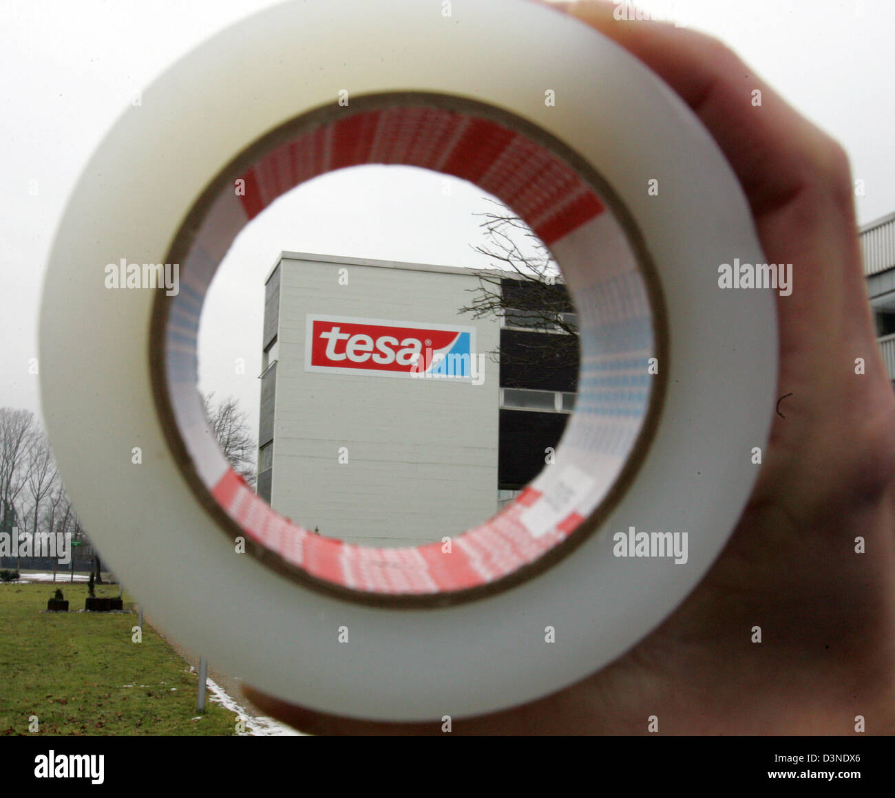 The picture shows a view onto the tesa AG's logo through a roll of ...