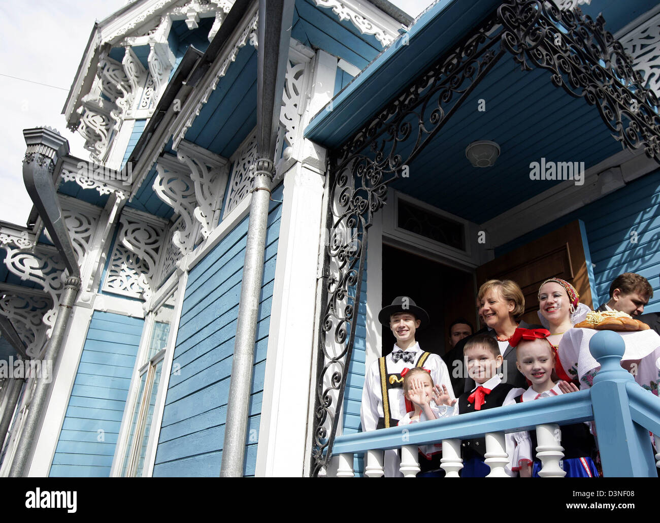 German federal Chancellor Angela Merkel and Russian children stand on ...