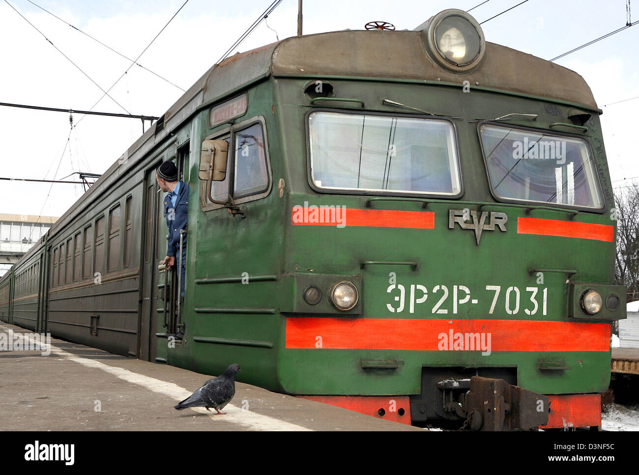 A train conductor checks the platform before leaving the Leningrad ...