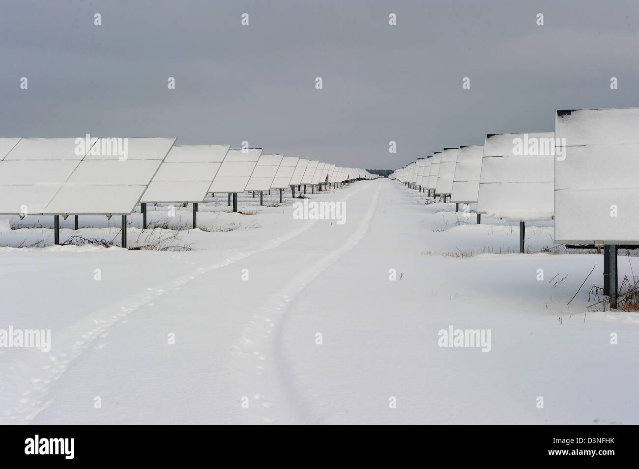 Solar panels are covered with snow at the solar park in Meuro, Germany ...