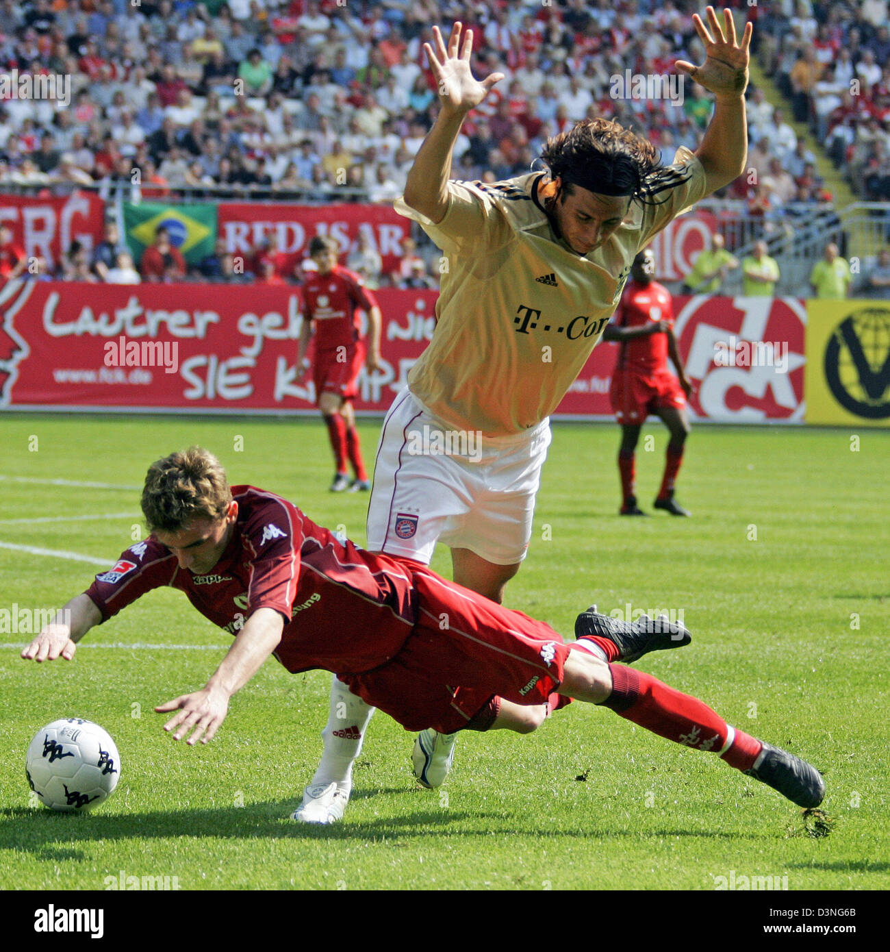 Sebastian Reinert (B) of Kaiserslautern falls before Munich's Caludio ...