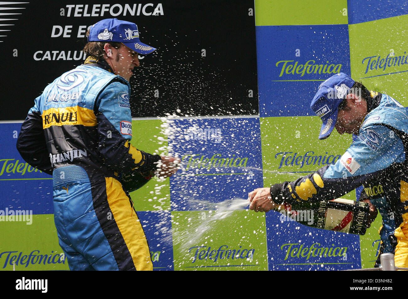 Spanish Formula One driver Fernando Alonso (L) and his Italian team-mate Giancarlo Fisichella of ...