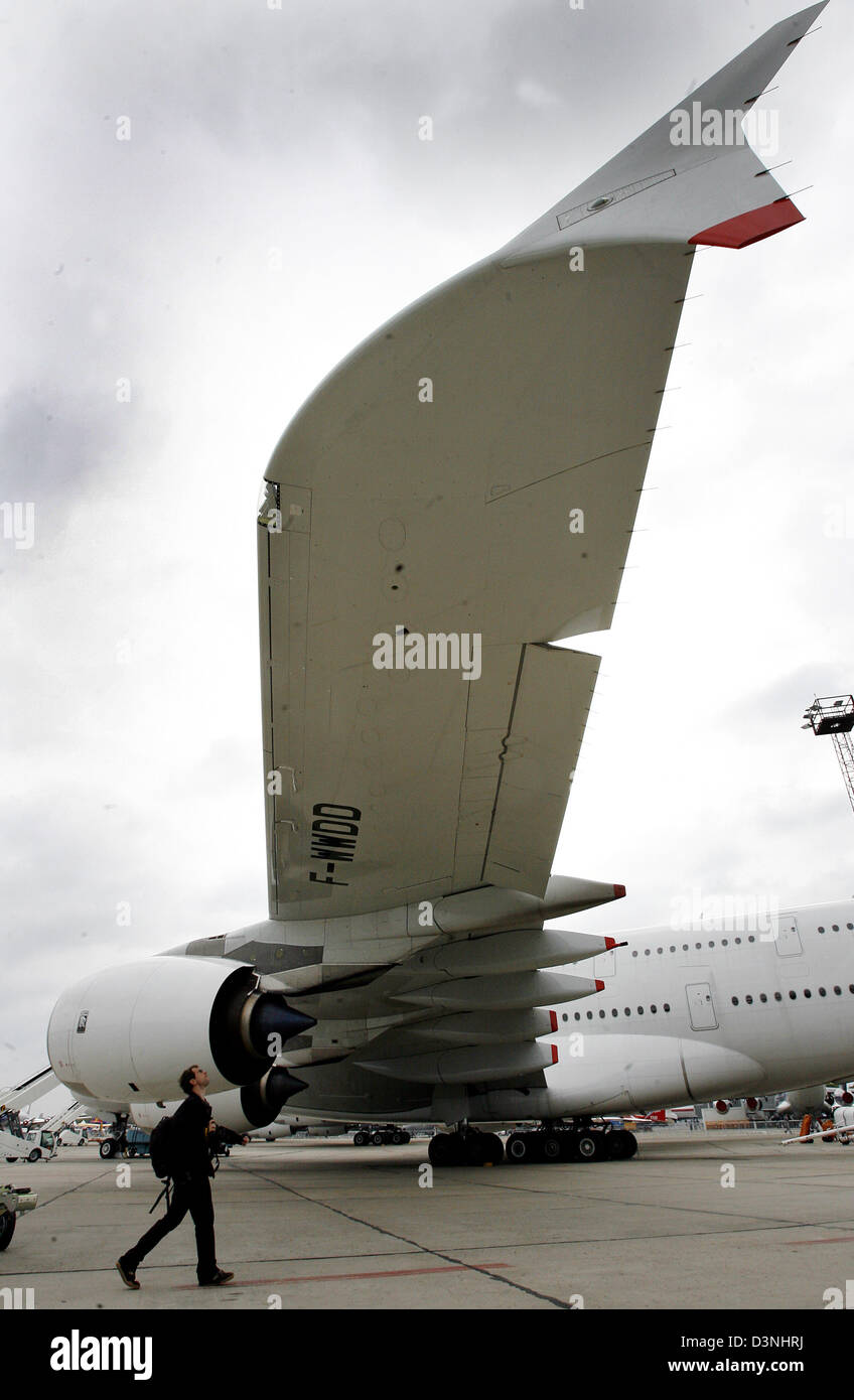 A spectator walks underneath the wing of an Airbus A380 aircraft at the ...