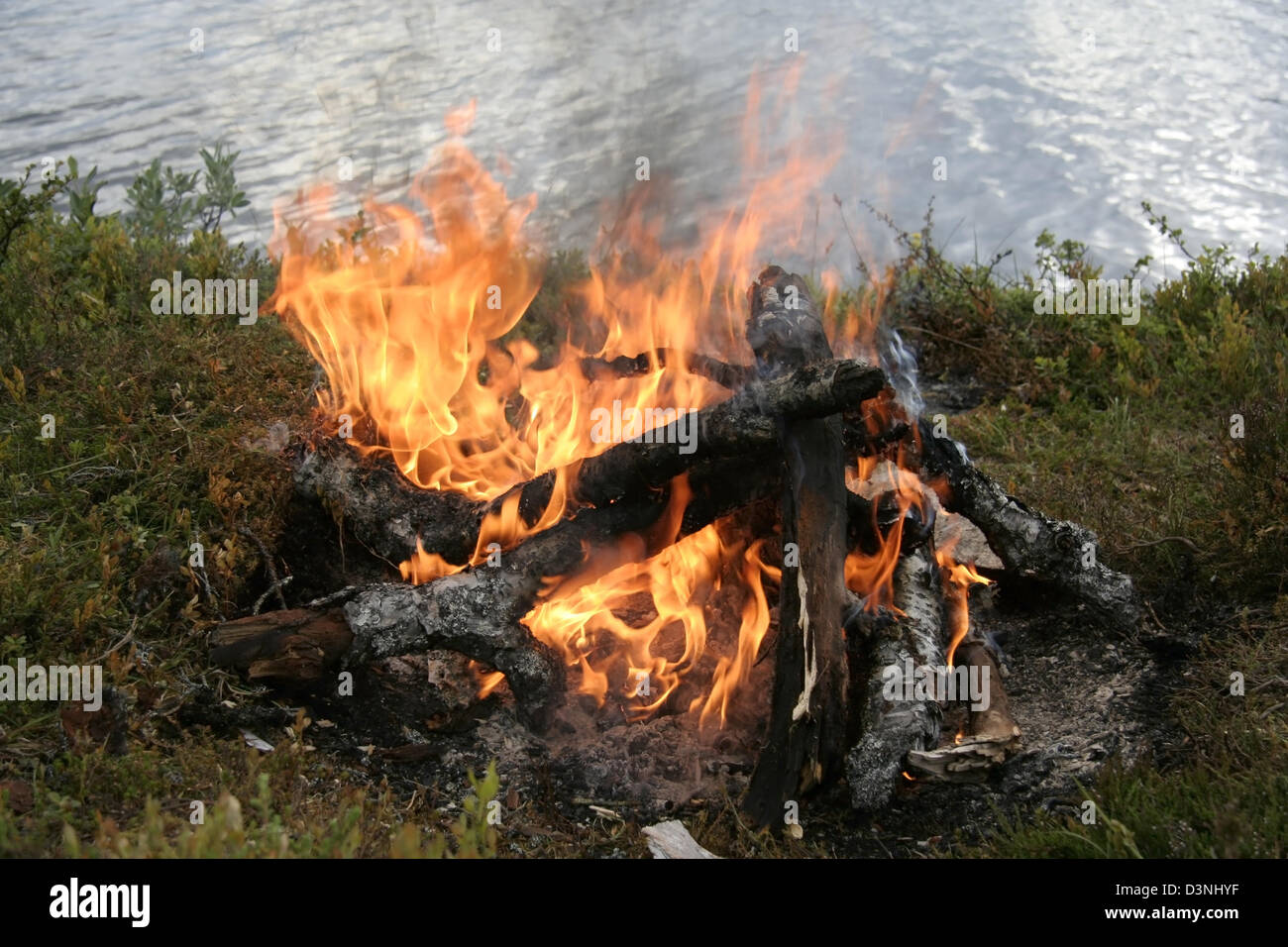 Camp fire by the lake Stock Photo - Alamy