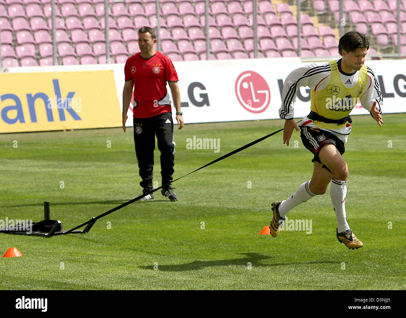 German international Michael Ballack (R) works hard under the eyes of ...