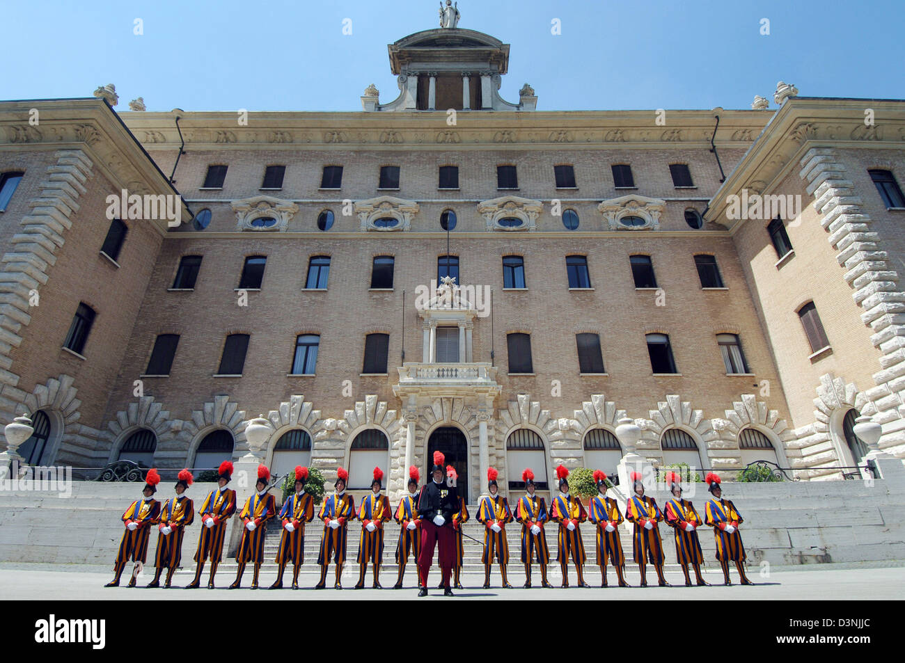 Swiss Guard soldiers with their colourful uniforms stand in front of a ...