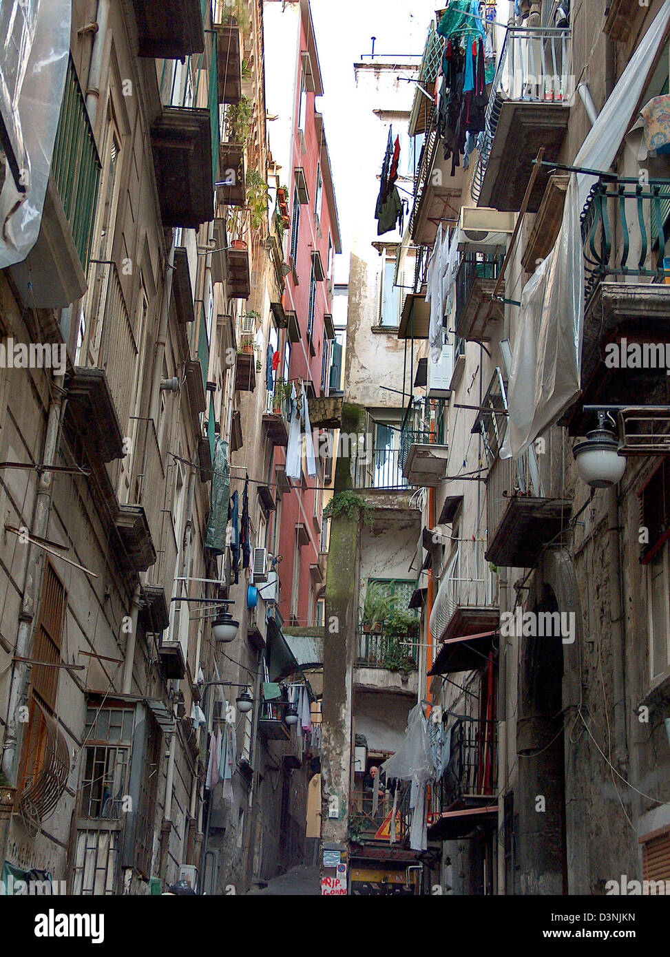 The photo shows the view into an alley of the old city part of Naples ...