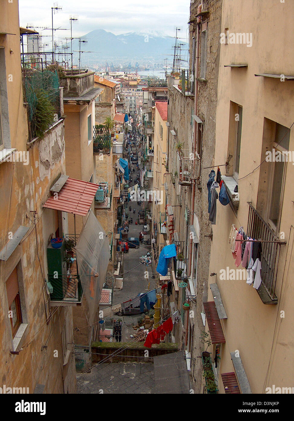 The photo shows the view into an alley of the old city part of Naples ...