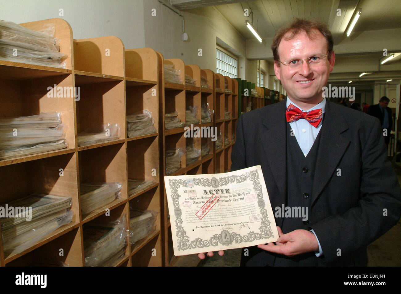Winfried Bogon shows one of the shares that will be auctioned on 3 June ...