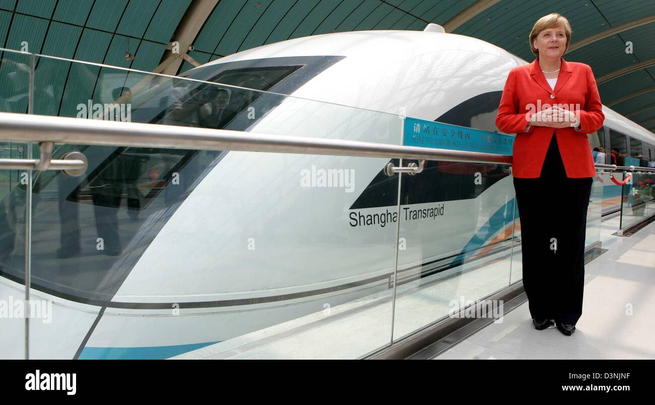 German Chancellor Angela Merkel stands in front of a Transrapid train ...