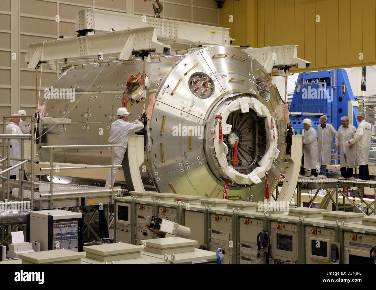 With the use of a crane scientists transfer spacelab 'Columbus' to a ...