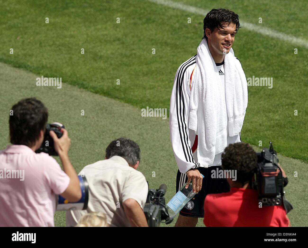 German national player Michael Ballack walks past media representatives ...