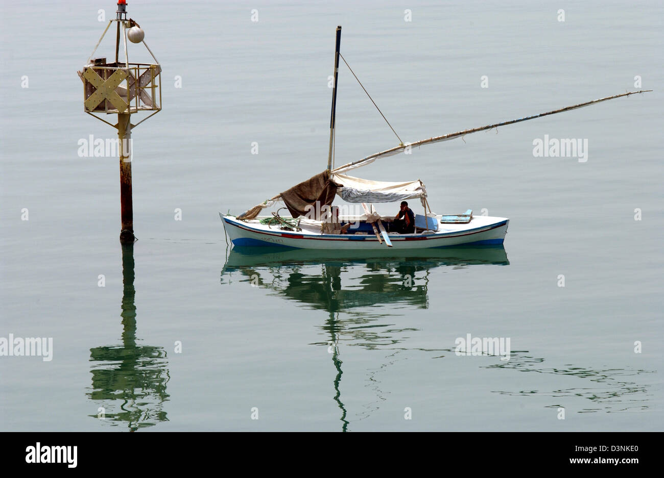 Two men fish on the Suez Canal, Egypt, 17 April 2006. The 195 ...