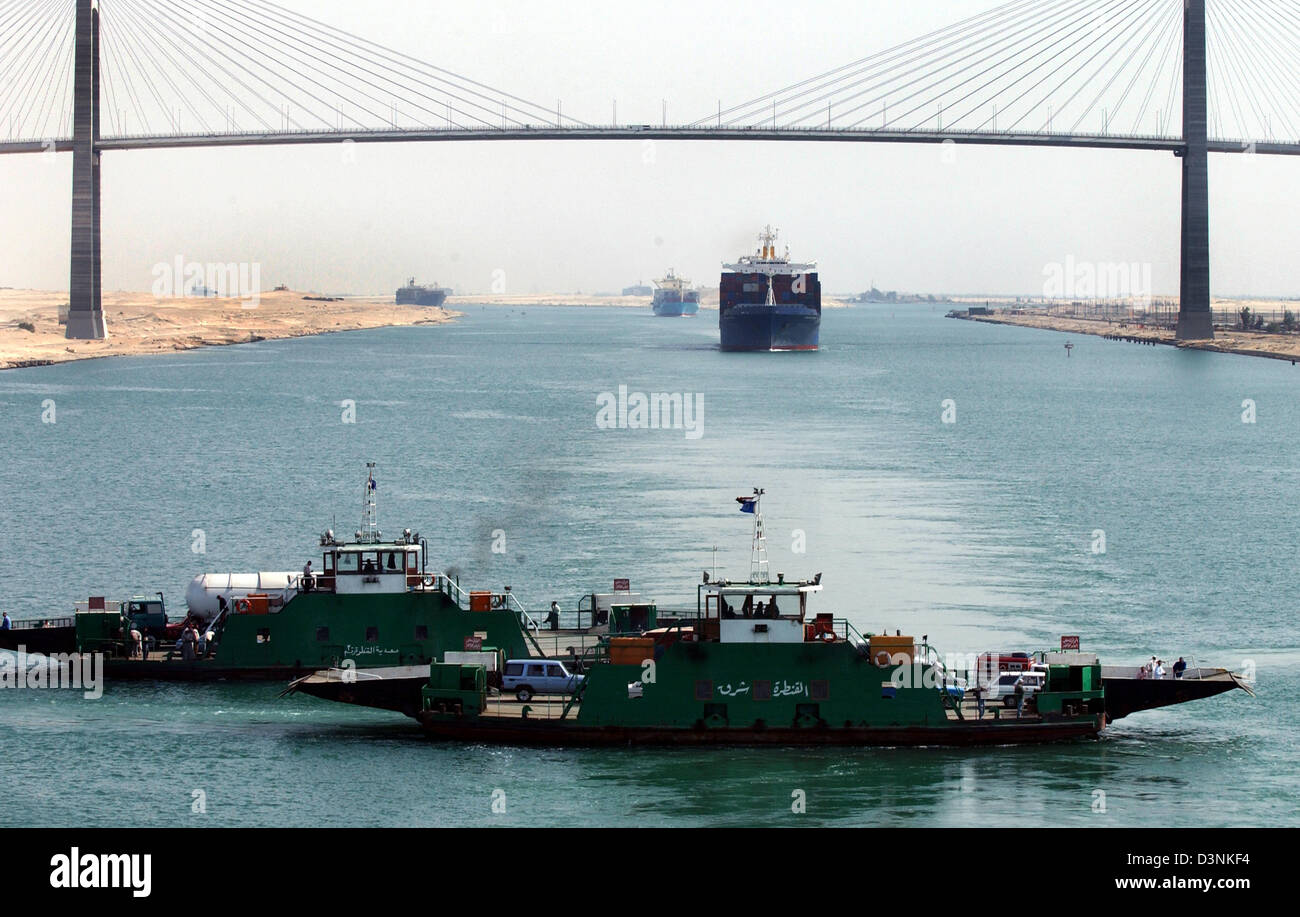 Cargo ships and ferries pass the 70 metres El Qantara bridge over the ...