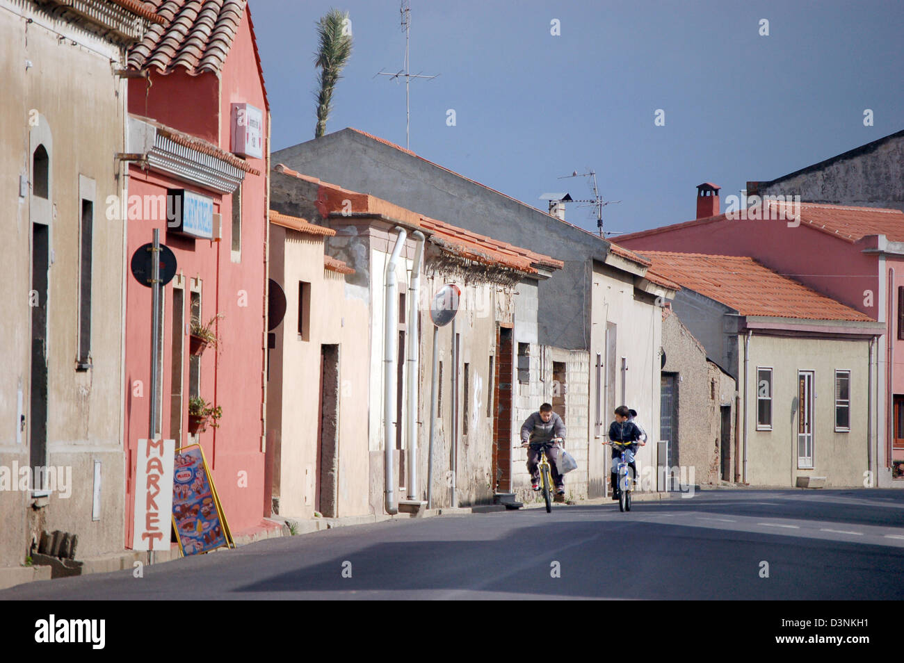 The photo shows the high street of the small town of Riola Sardo on the ...