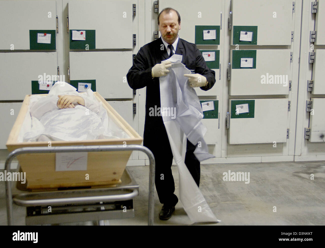 An Employee of the funeral undertaker Karl Schumacher prepares a corpse ...