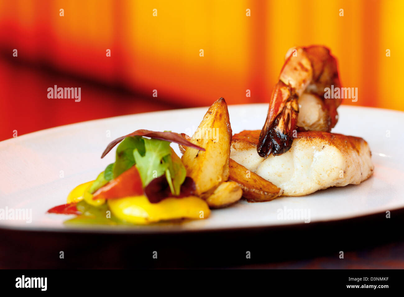 Seafood combo, consisting of cod & king prawn served with roasted ...