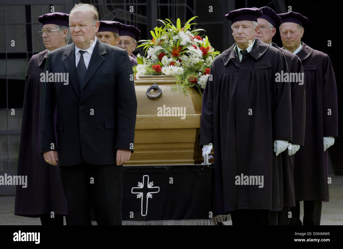 Pallbearers of funeral undertaker Karl Schumacher carry a coffin in a ...