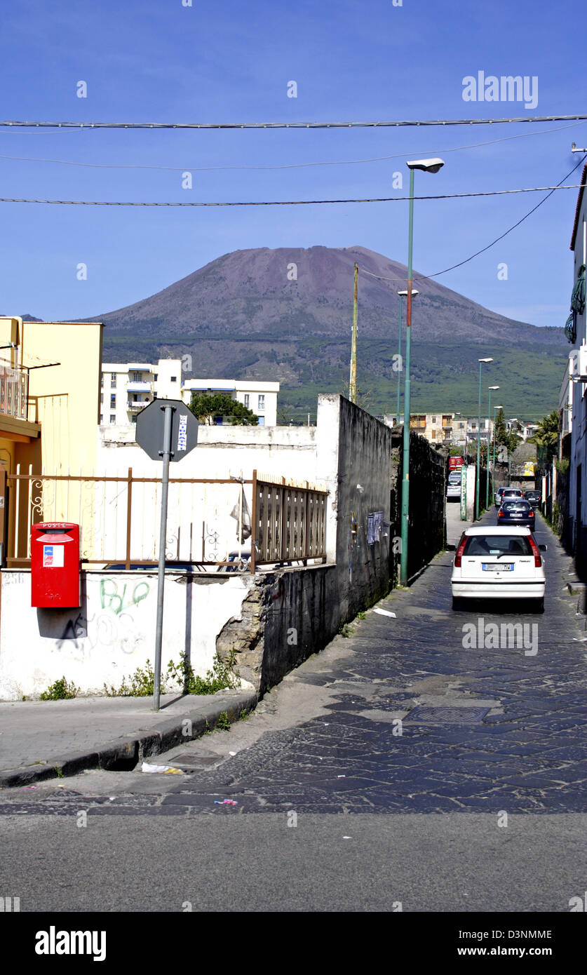 The photo shows a street scene in Torre Annunziata beneath the Vesuvius ...